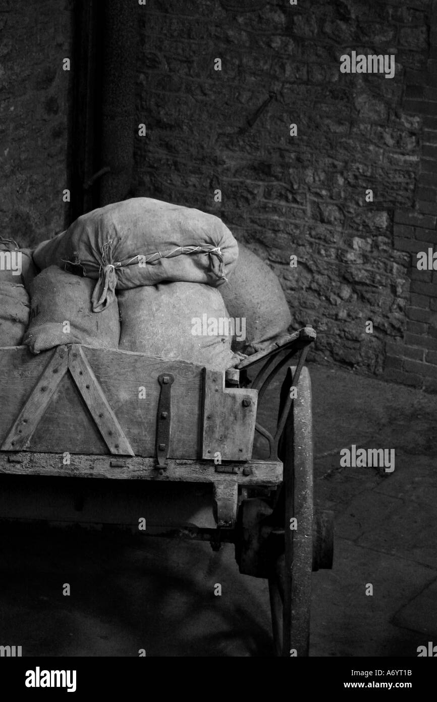 Cart and sacks at old paper mill Black and white UK Stock Photo - Alamy