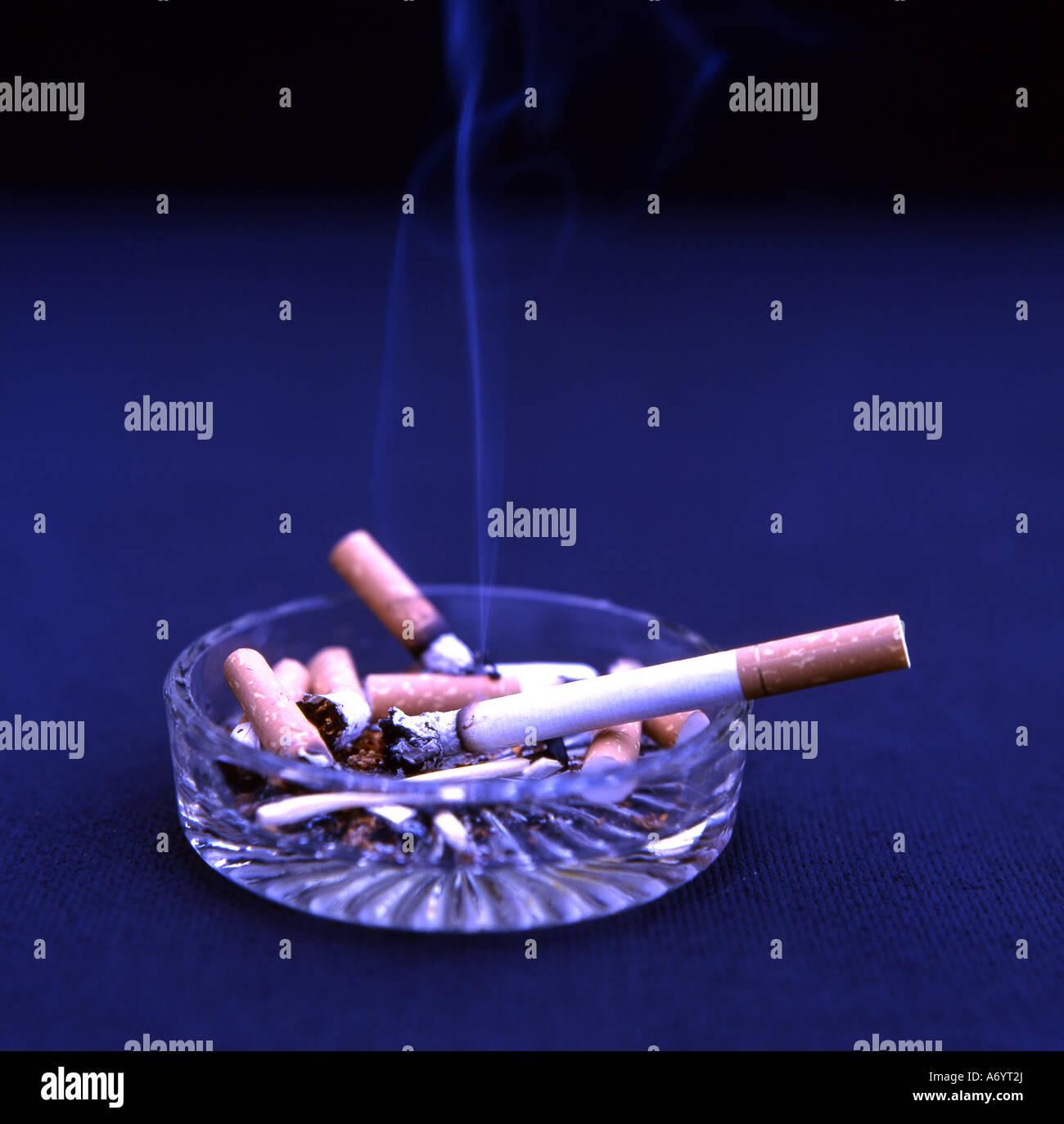 Cigarette in ashtray with smoke Stock Photo - Alamy