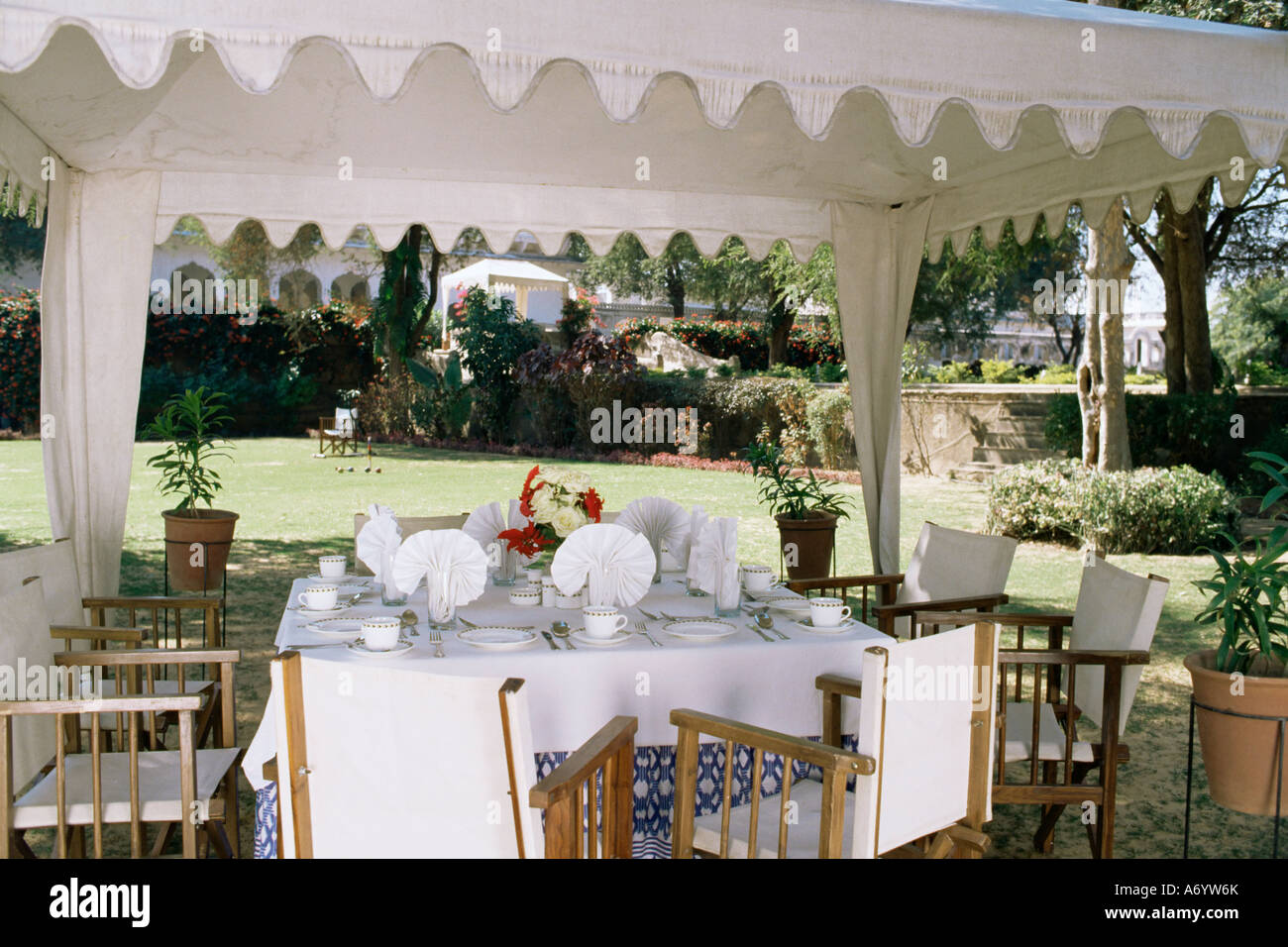 Dining under tented awnings in the garden with croquet set in the ...
