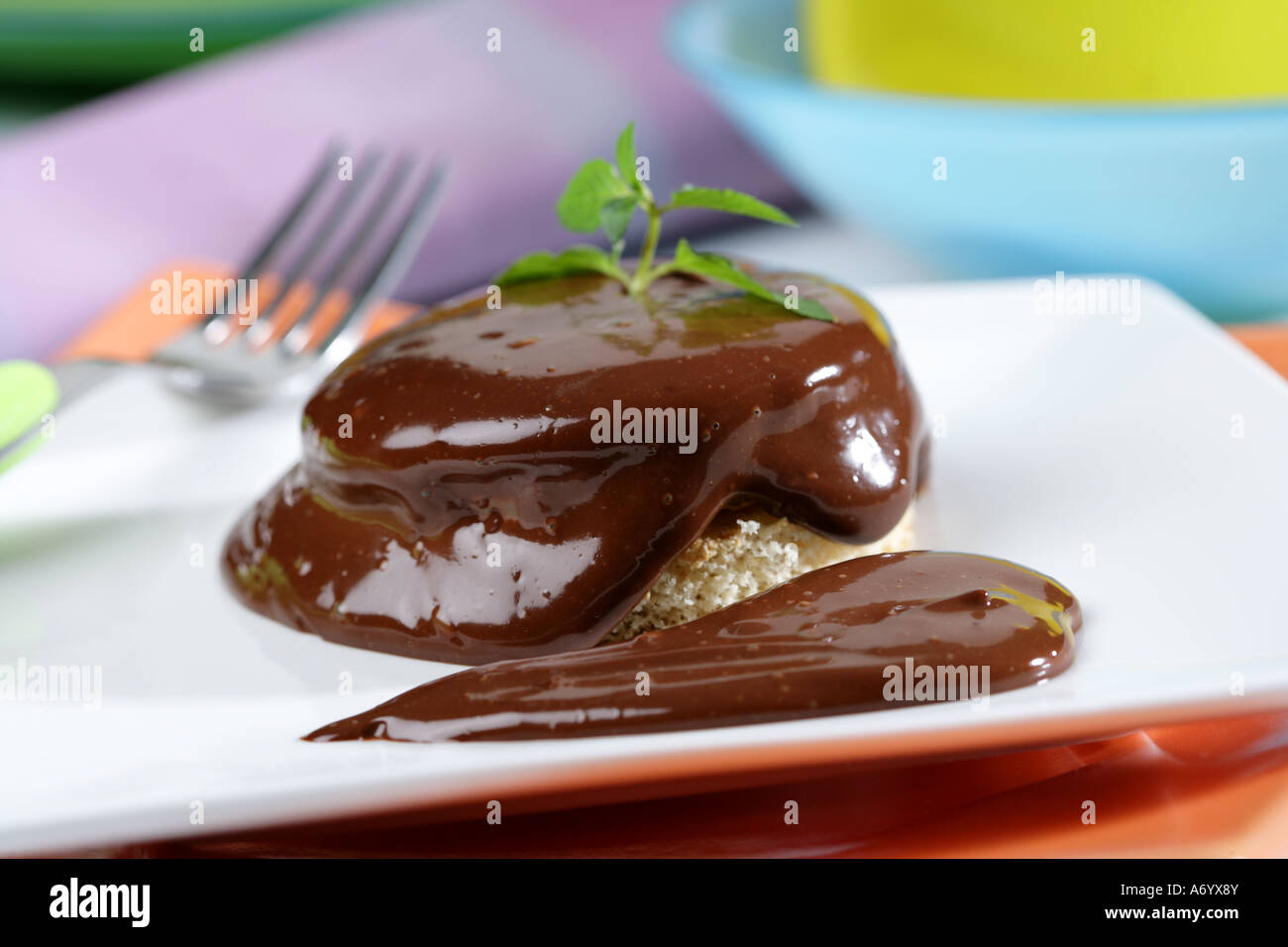 Chocolate cream covering sponge cake Stock Photo - Alamy
