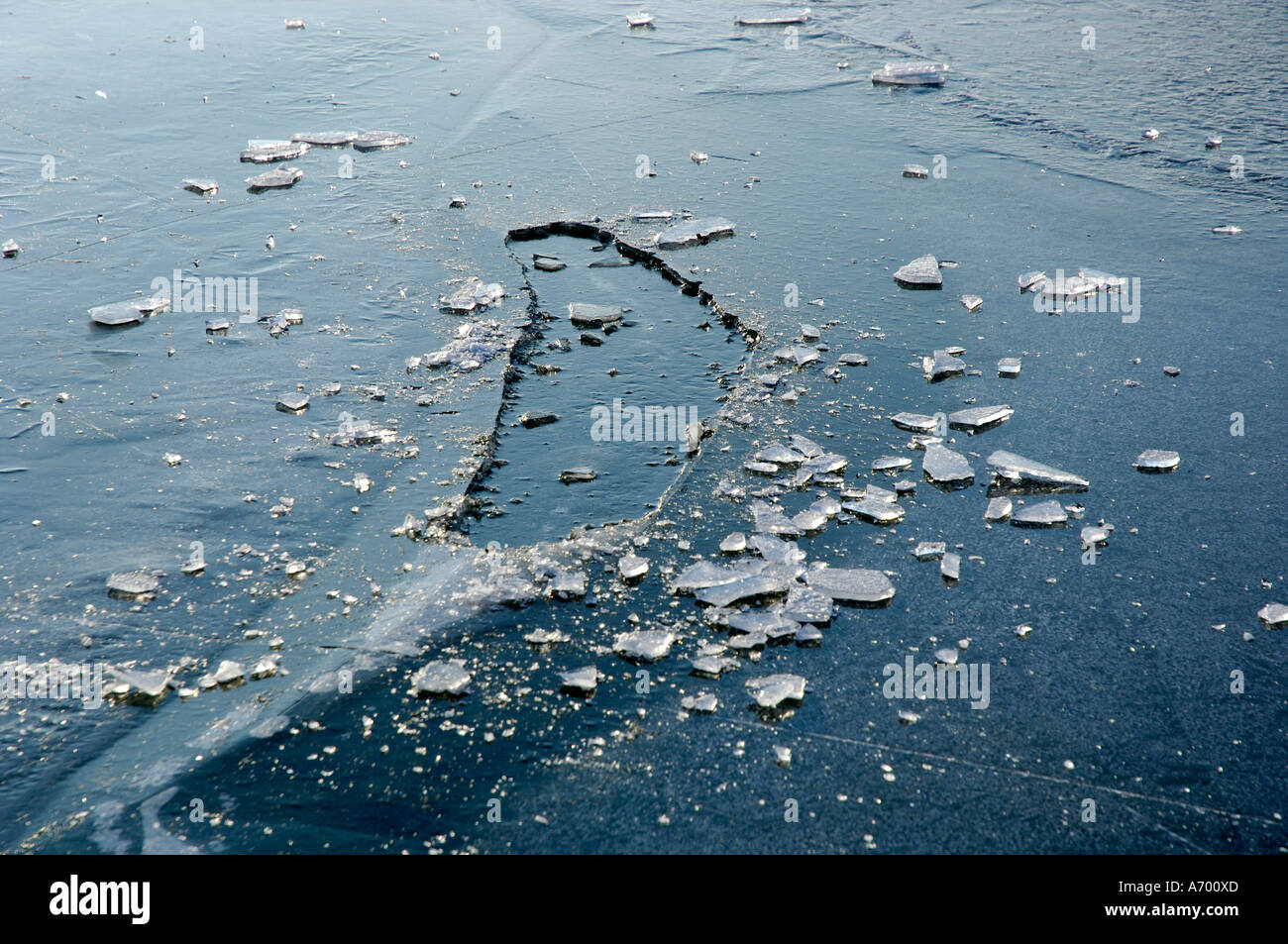 A frozen hole in a frozen ice on a lake Stock Photo - Alamy