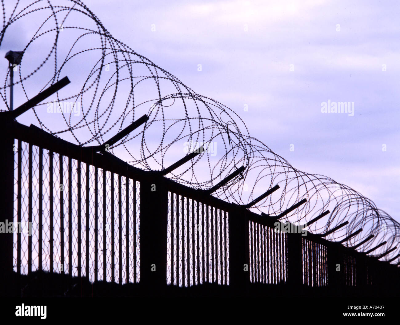 fence fence post spike barb barrier Stock Photo - Alamy