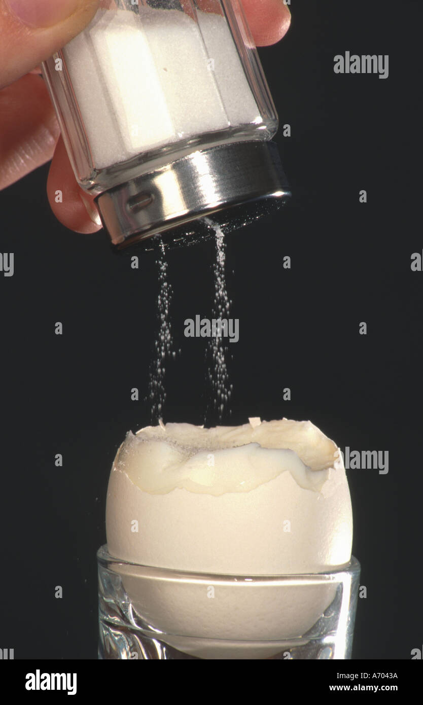 food spice salt hand with a saltshaker salting an egg Stock Photo - Alamy