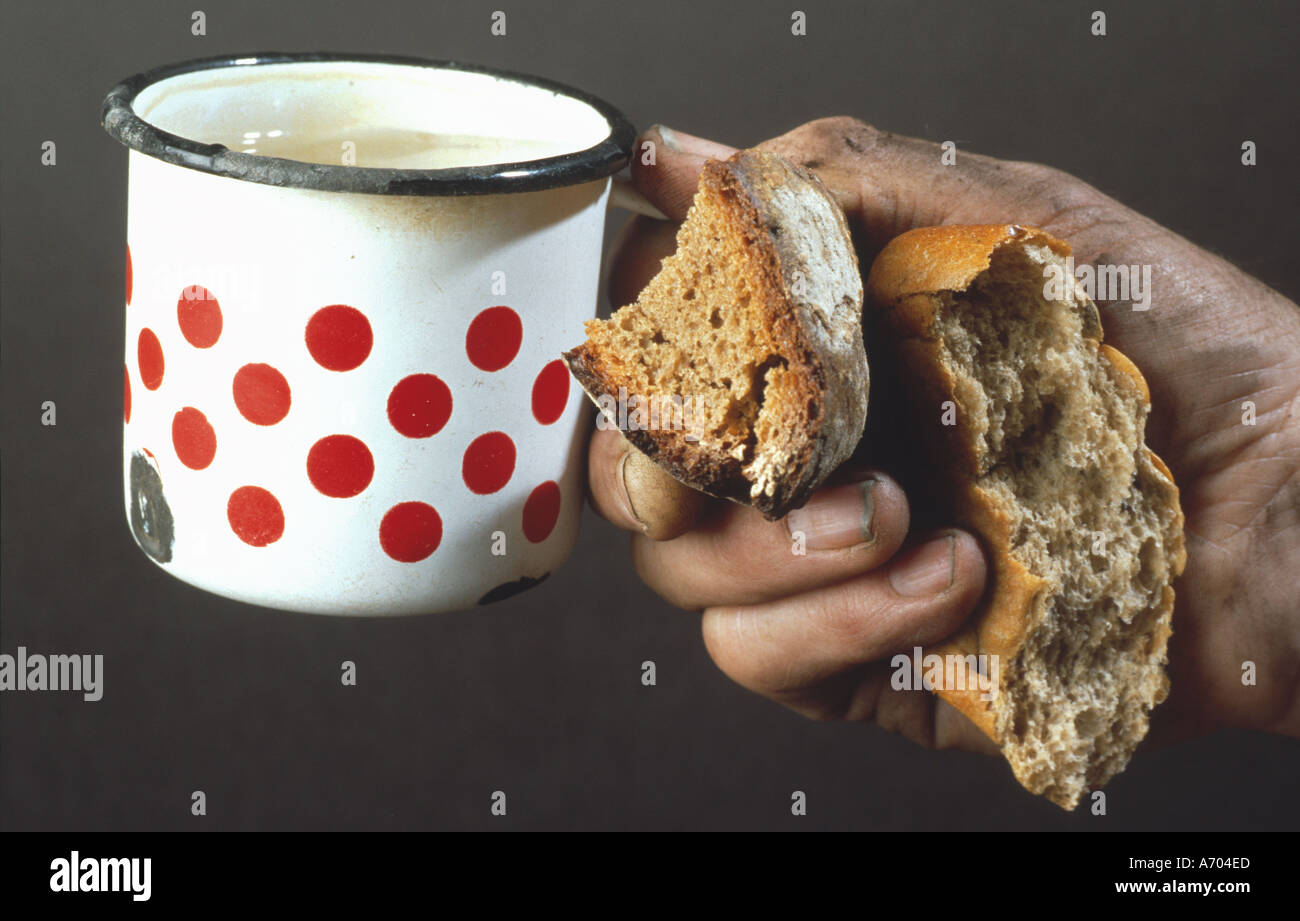 water and bread hand holding a small pot of water and a piece of bread ...