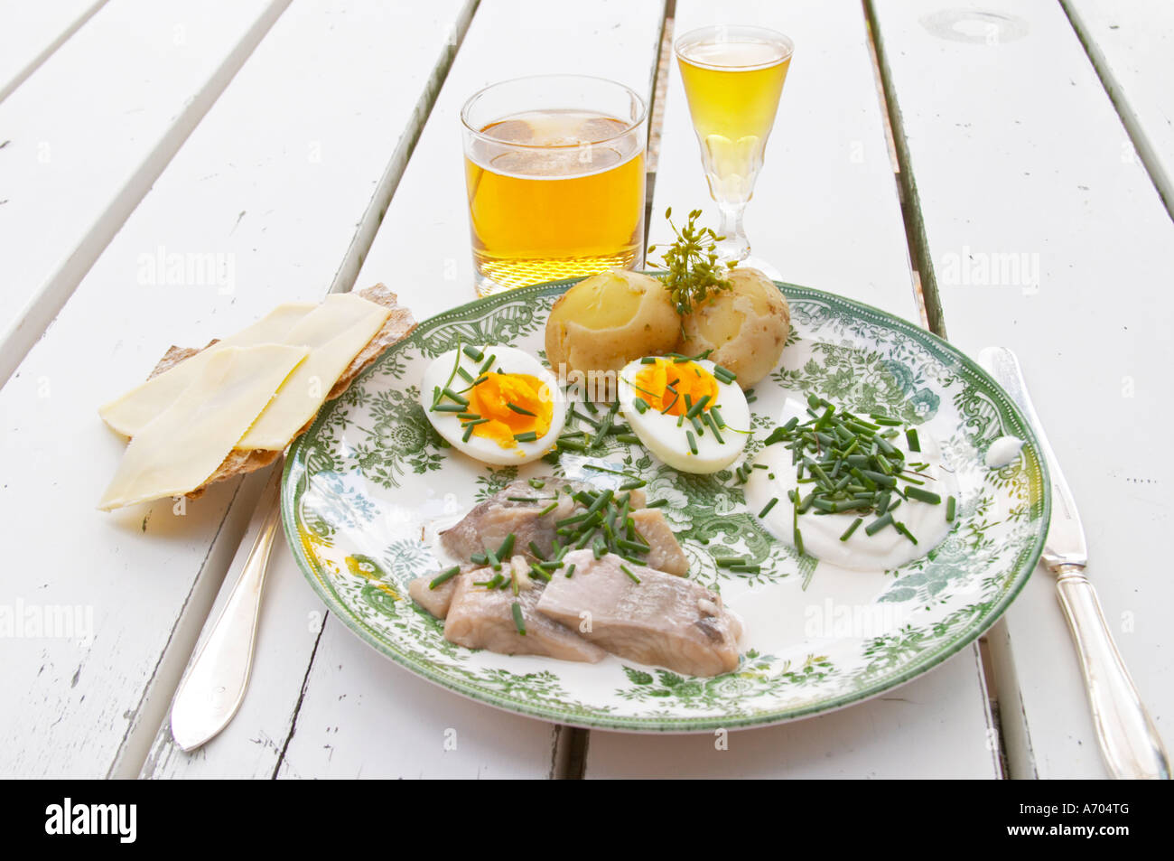 Traditional Swedish summer lunch with marinated herring sill, boiled ...