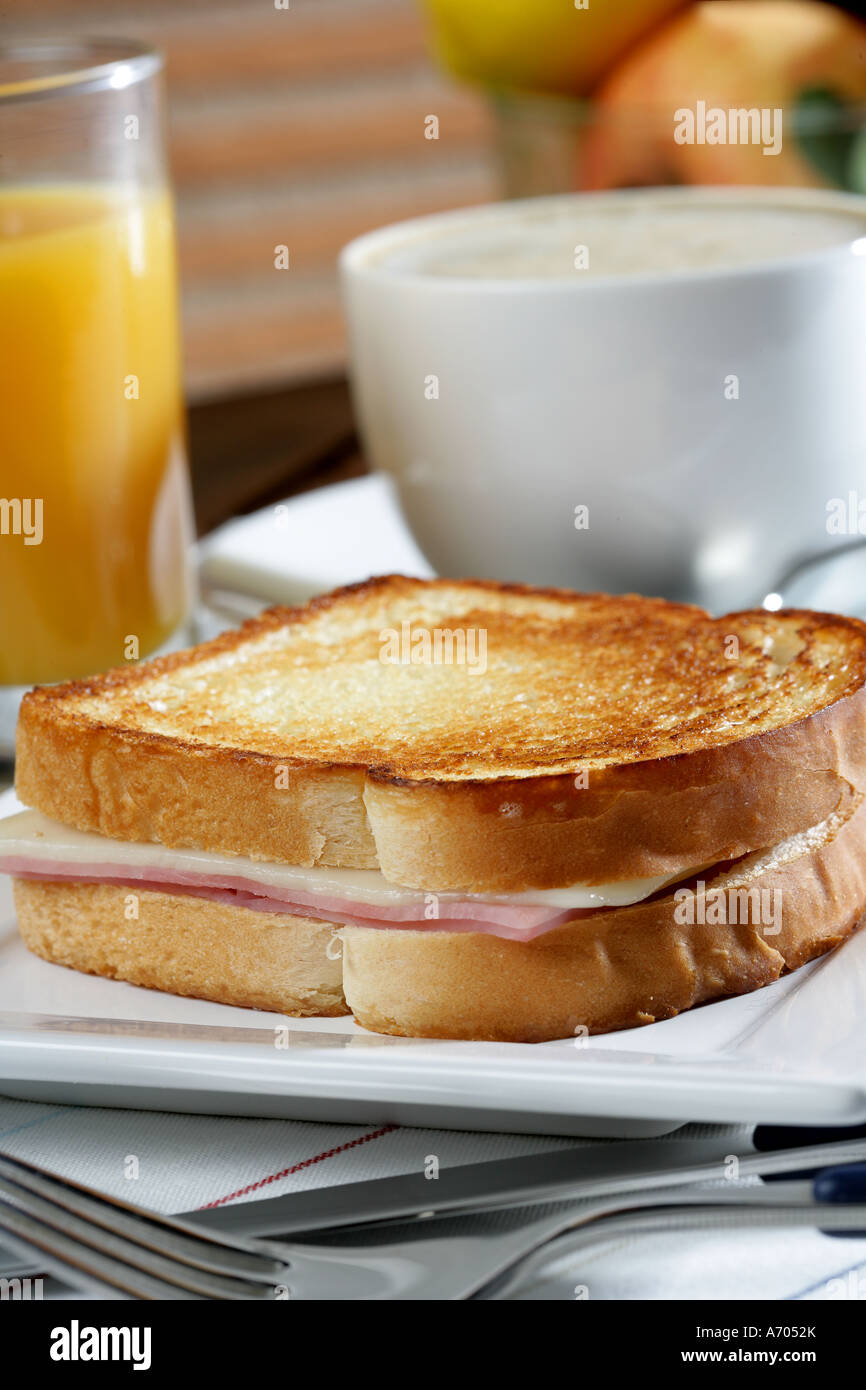Breakfast coffee with milk ham and cheese sandwich orange juice and ...