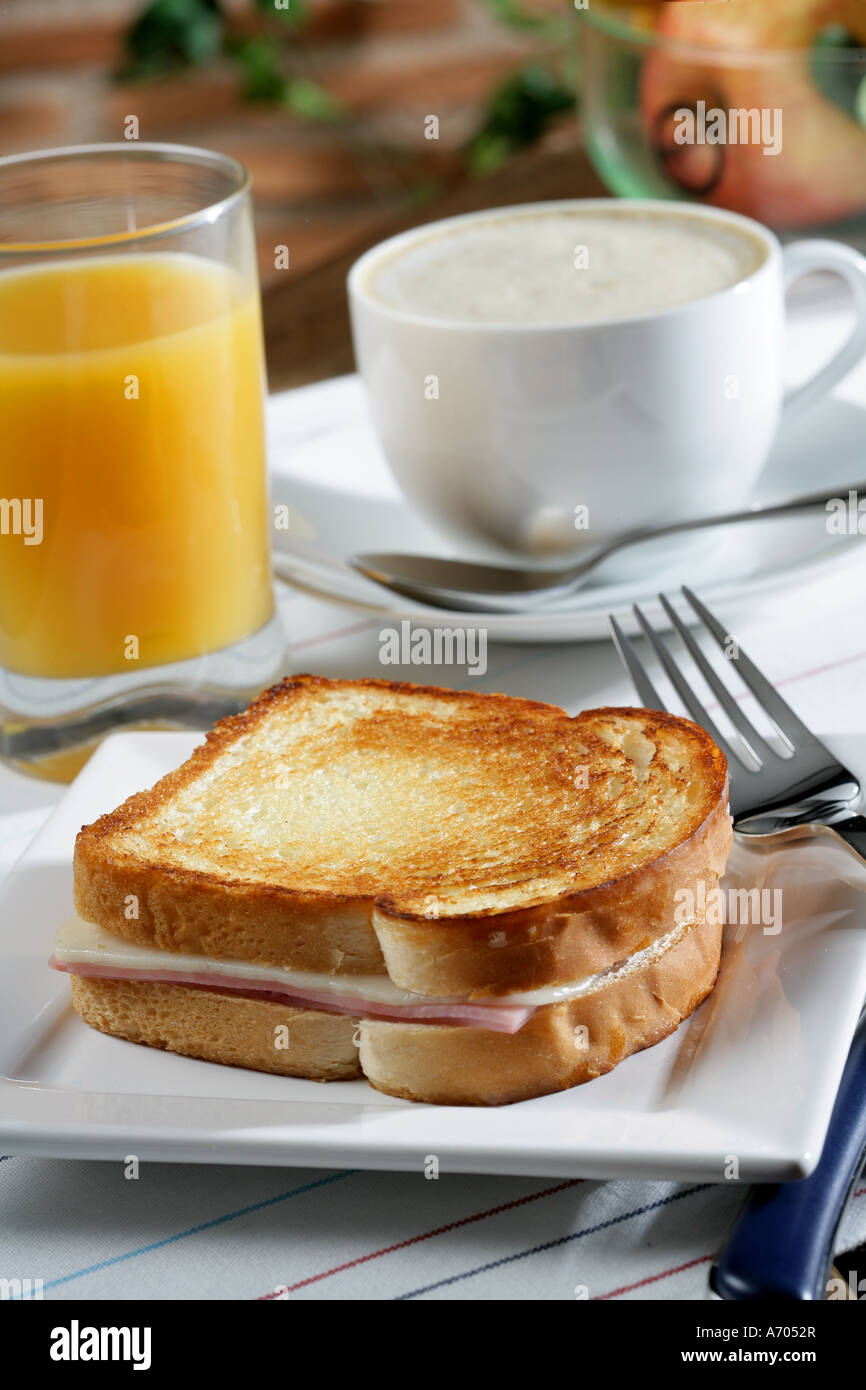 Breakfast coffee with milk ham and cheese sandwich orange juice and ...