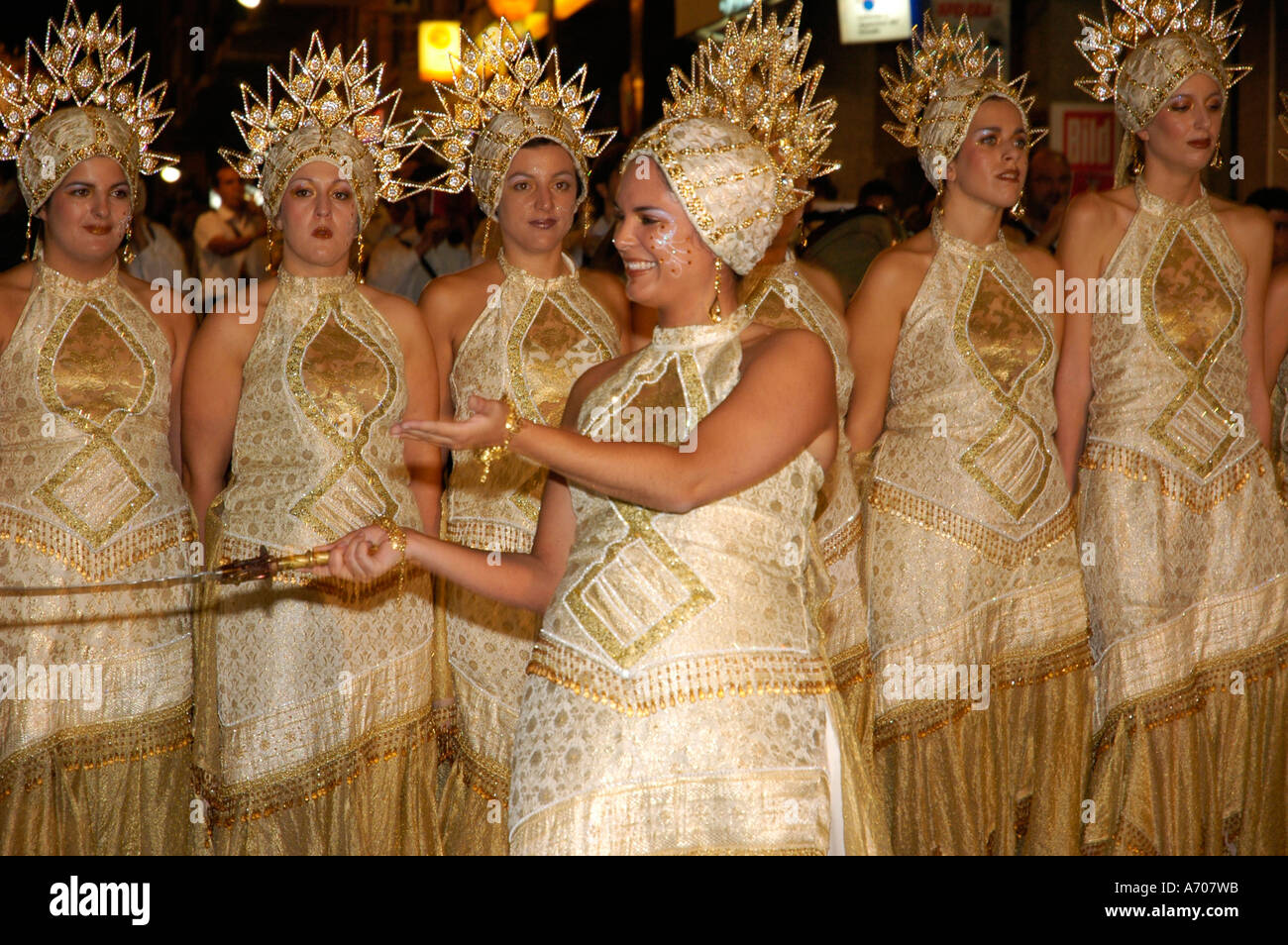 Festively dressed women at a parade with sword, Fiesta, moros y ...