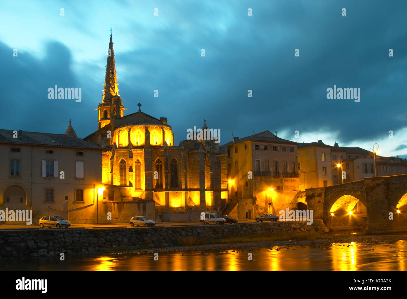 The gothic St Martin Church and the bridge across the l'Aude river ...