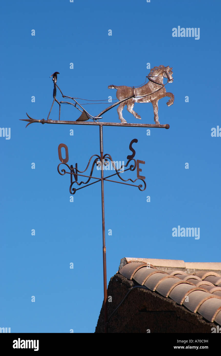 Weather vane with compass directions, depicting a horse and a man that ...
