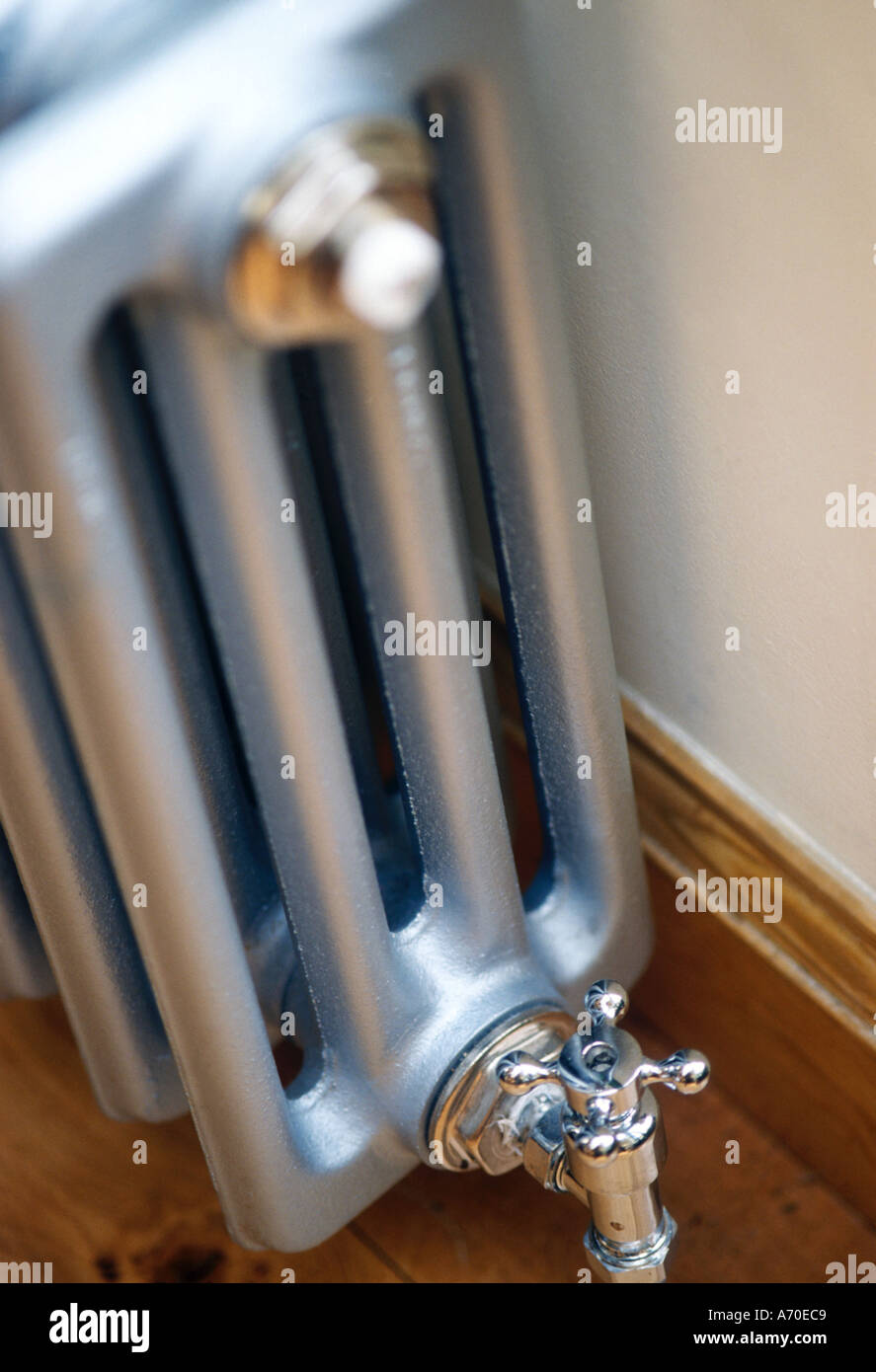 Classic old fashioned style radiator painted with silver paint with ...