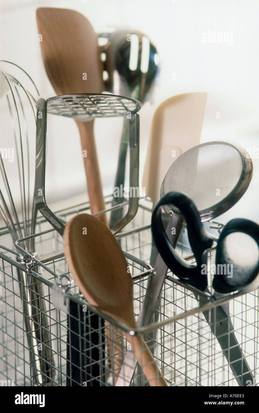 Kitchen utensils draining in chrome rack Stock Photo - Alamy