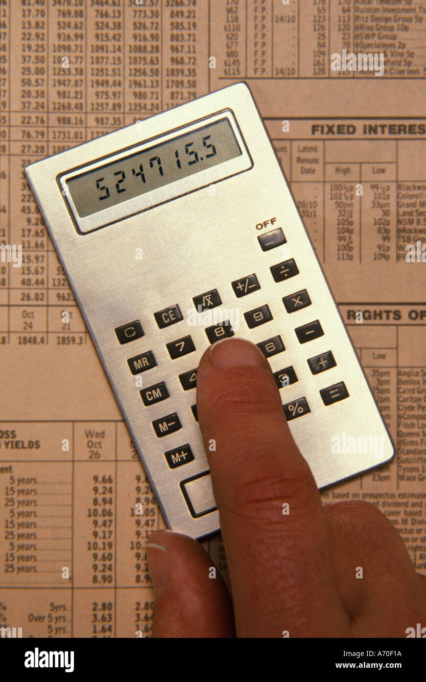 hand on calculator with financial paper Stock Photo - Alamy