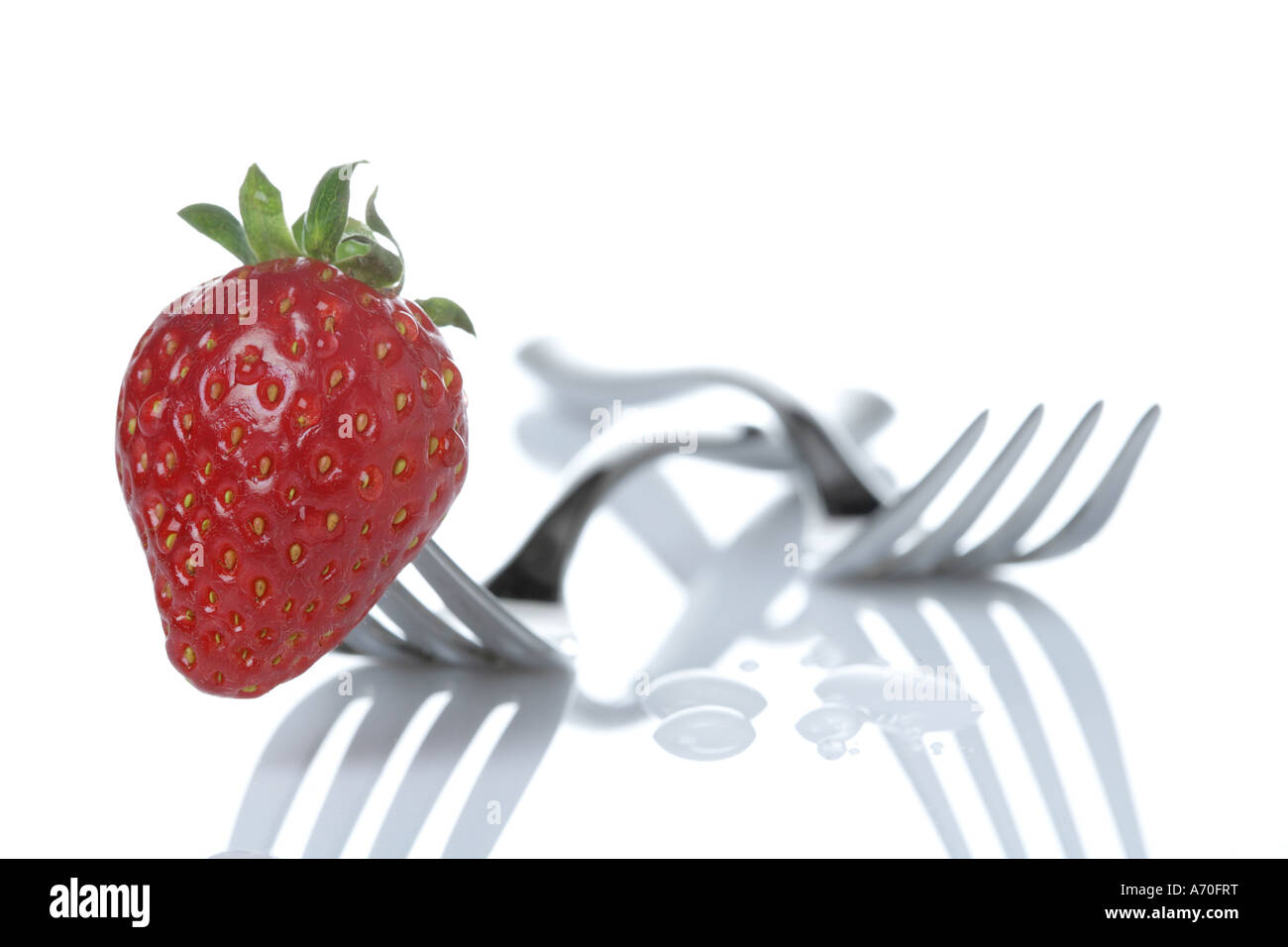 Strawberry and fork Stock Photo - Alamy
