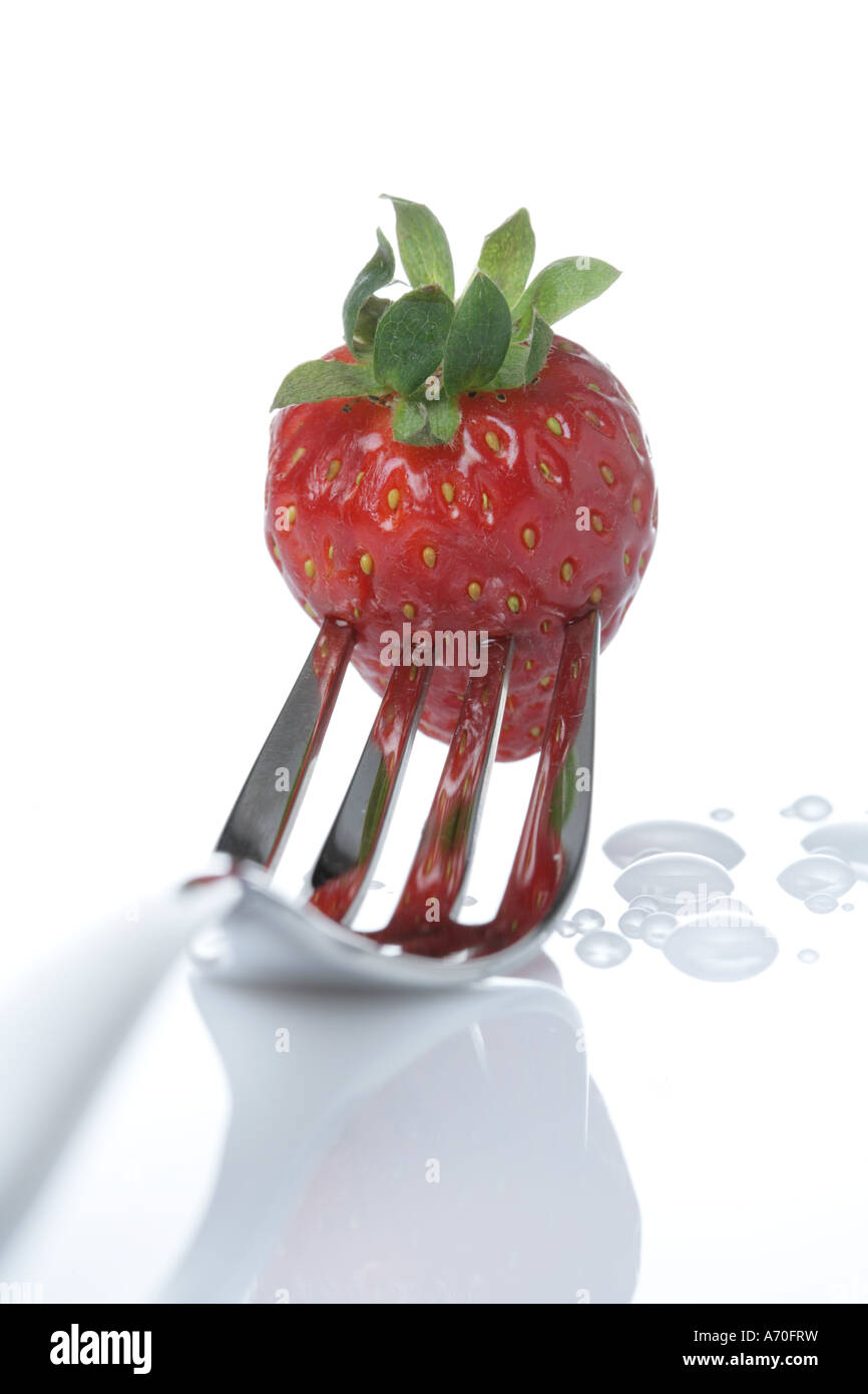 Strawberry and fork Stock Photo - Alamy