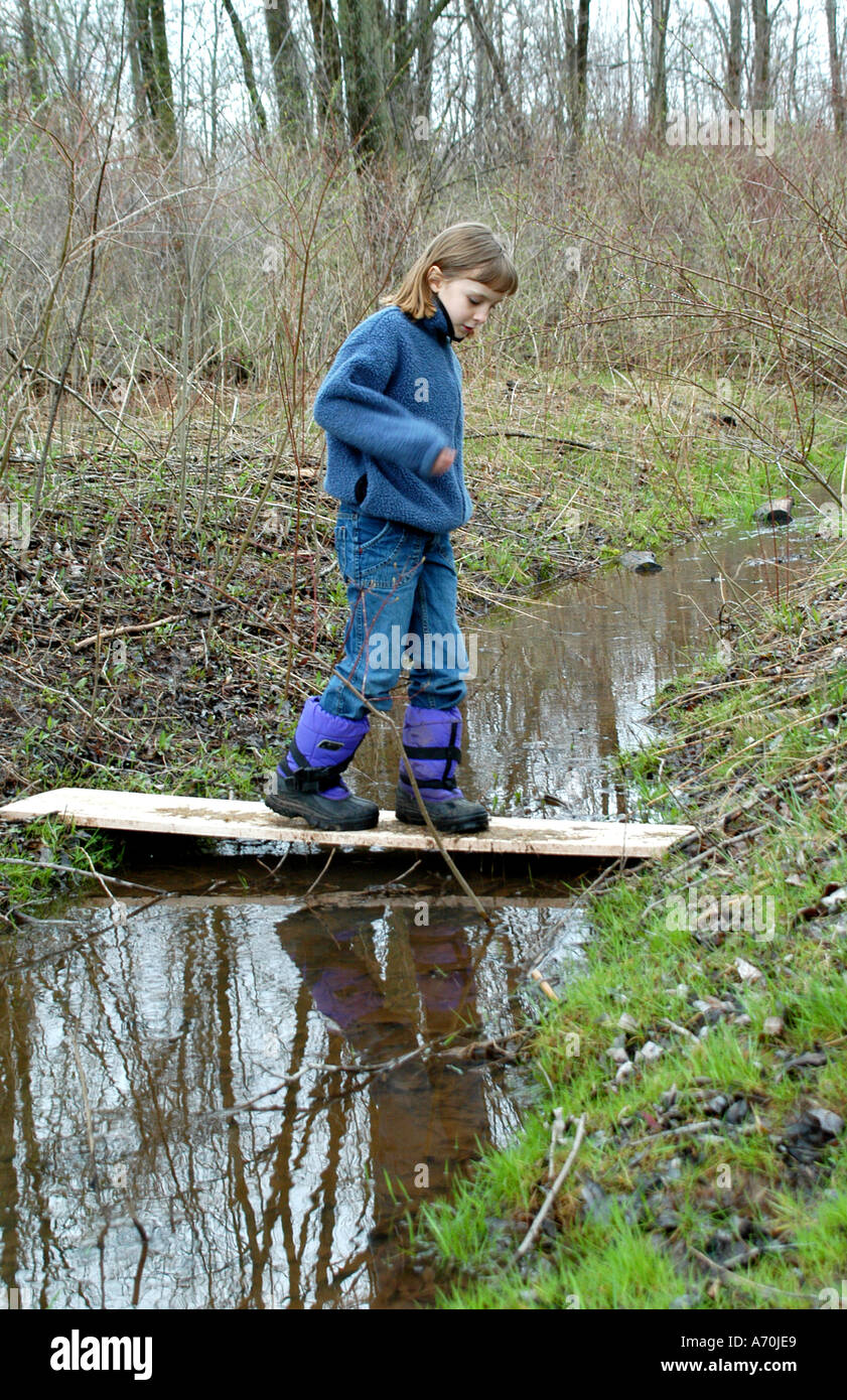 Child crosses bridge over stream Stock Photo - Alamy