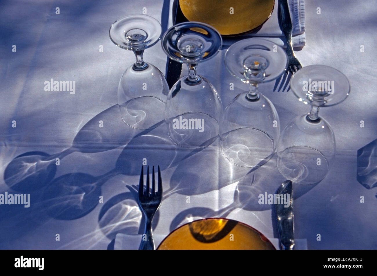 effects of light and shadow on a table with two place settings with ...