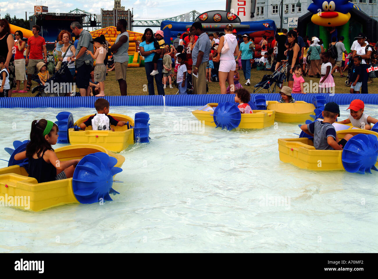 Young children playing with paddle boats during a fair Stock Photo - Alamy