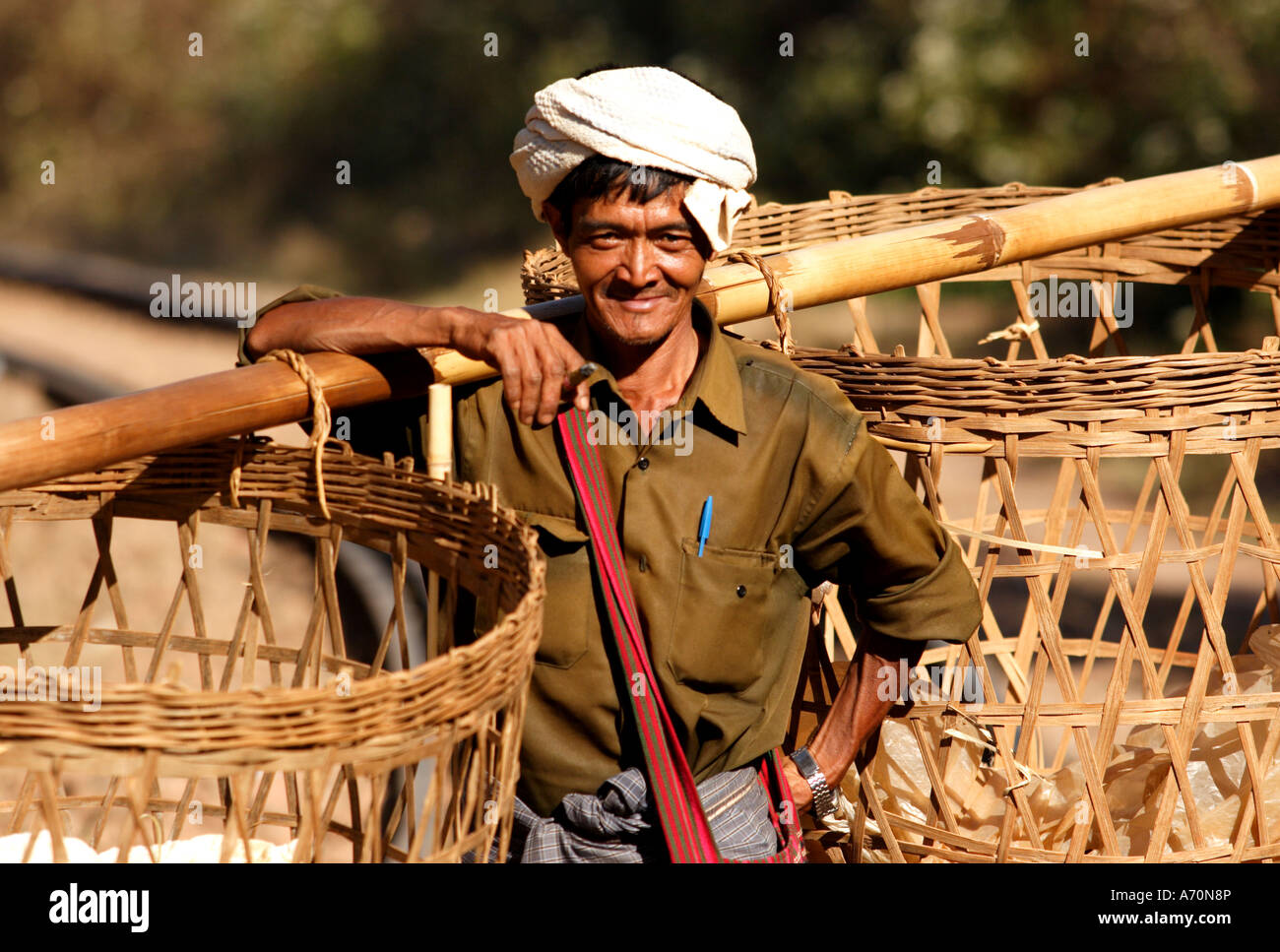 Asia, Myanmar, Burmese man carries load balanced on shoulder Stock ...
