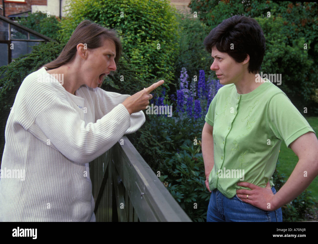 Two women fighting over fence hi-res stock photography and images - Alamy