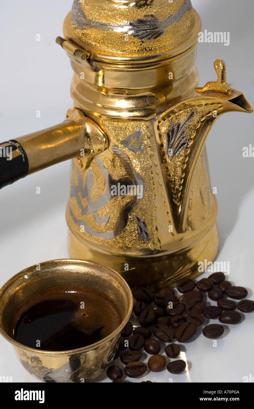 Traditional Syrian brass coffee-pot and cup on a white background with ...
