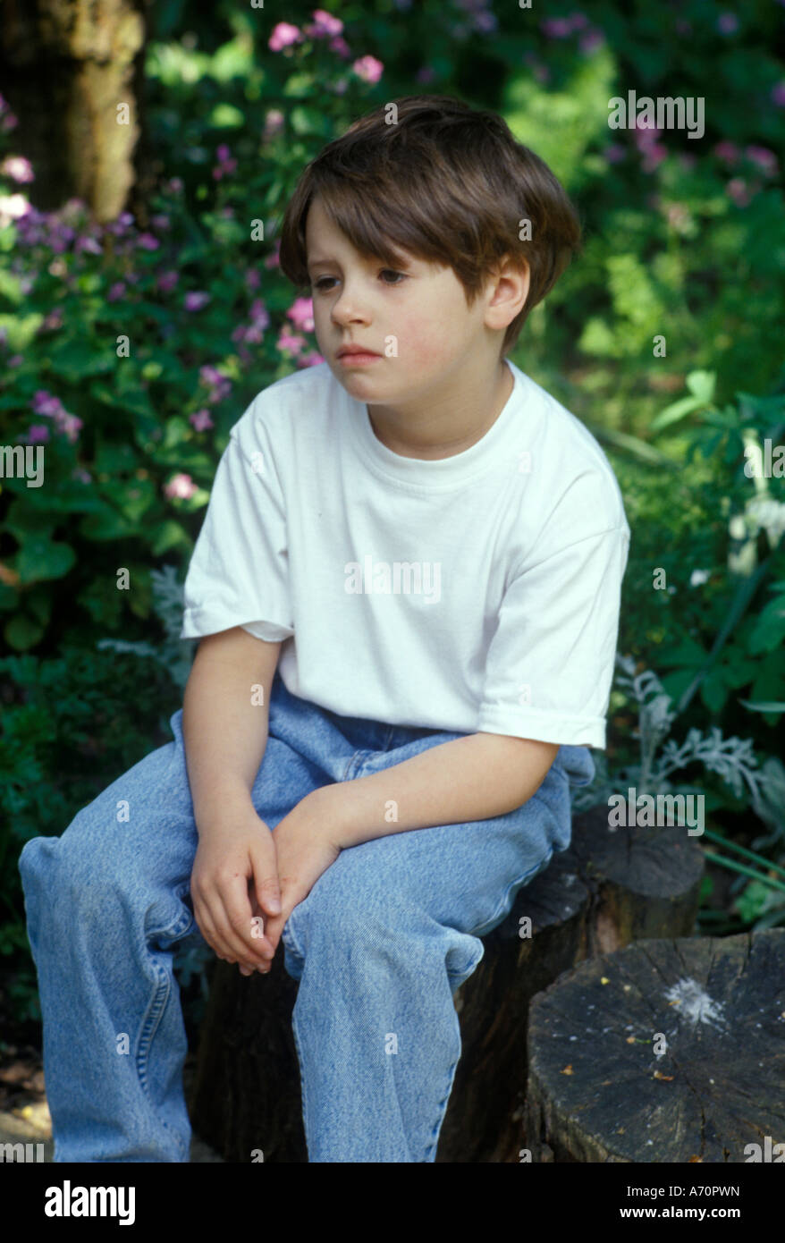 child sitting and looking miserable Stock Photo - Alamy