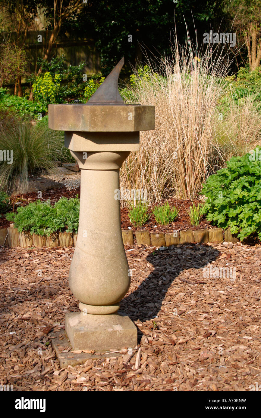 Dark Metal Sundial with ornamental stone base Stock Photo - Alamy