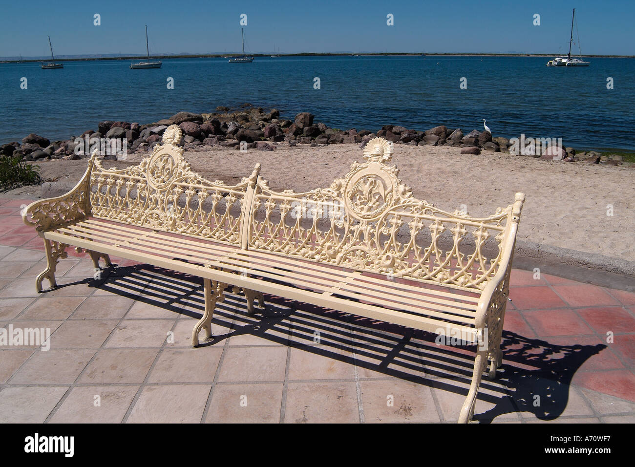 Bench on the beach front in Lapaz Stock Photo - Alamy