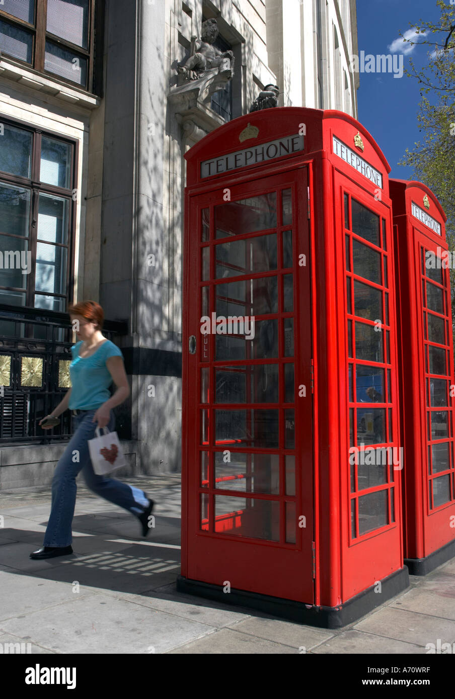 Two red traditional phone boxes with the label Telephone in the City of ...