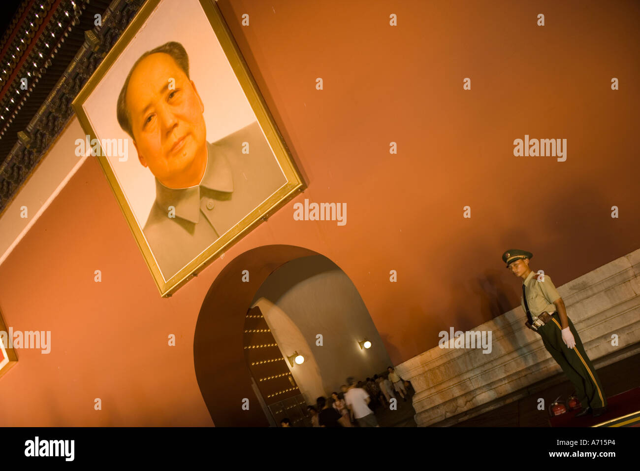 Asia China Beijing Policeman stands guard below portrait of Mao Zedong ...