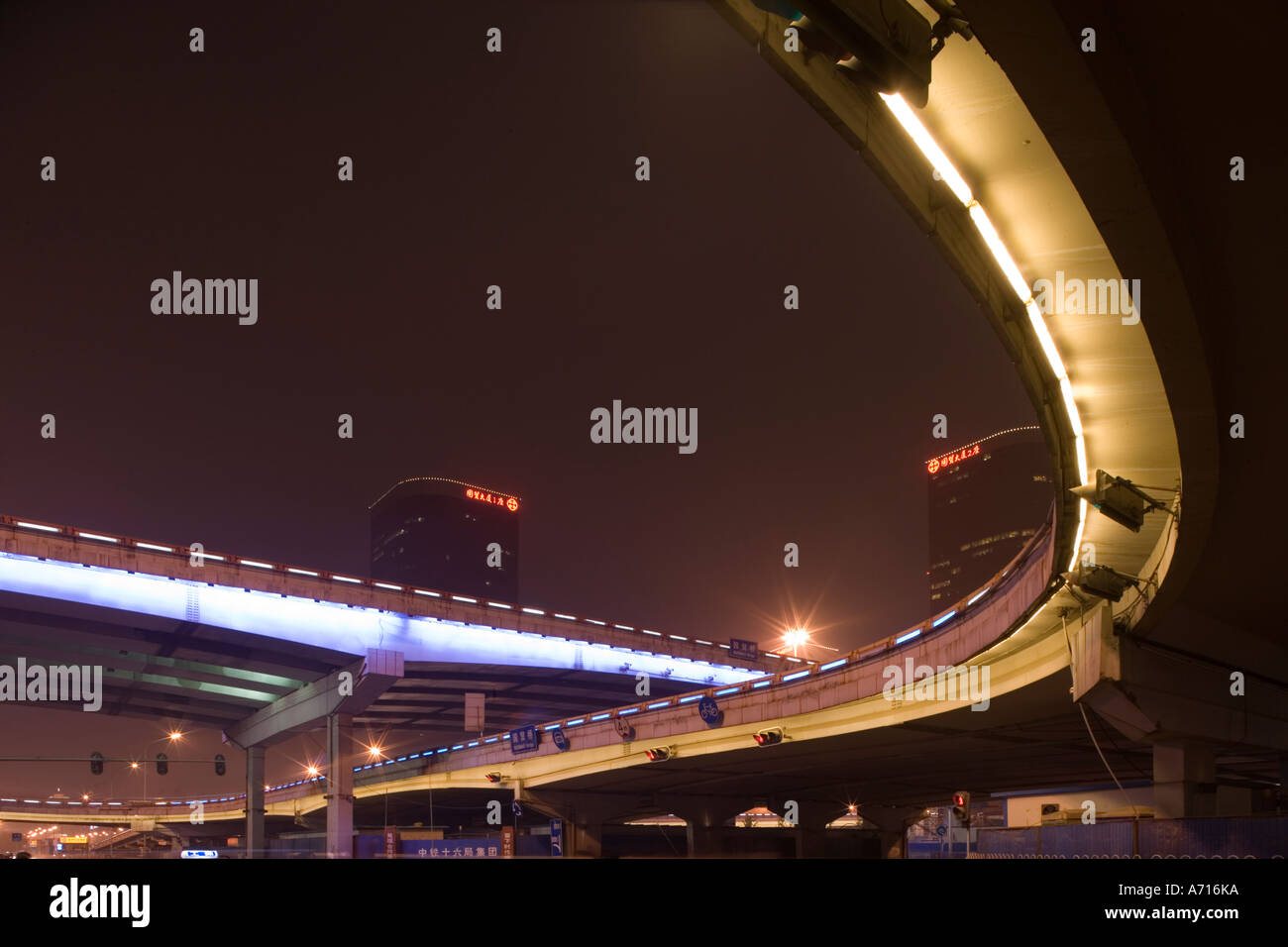 Asia China Beijing Lights of highway overpass and office towers at ...