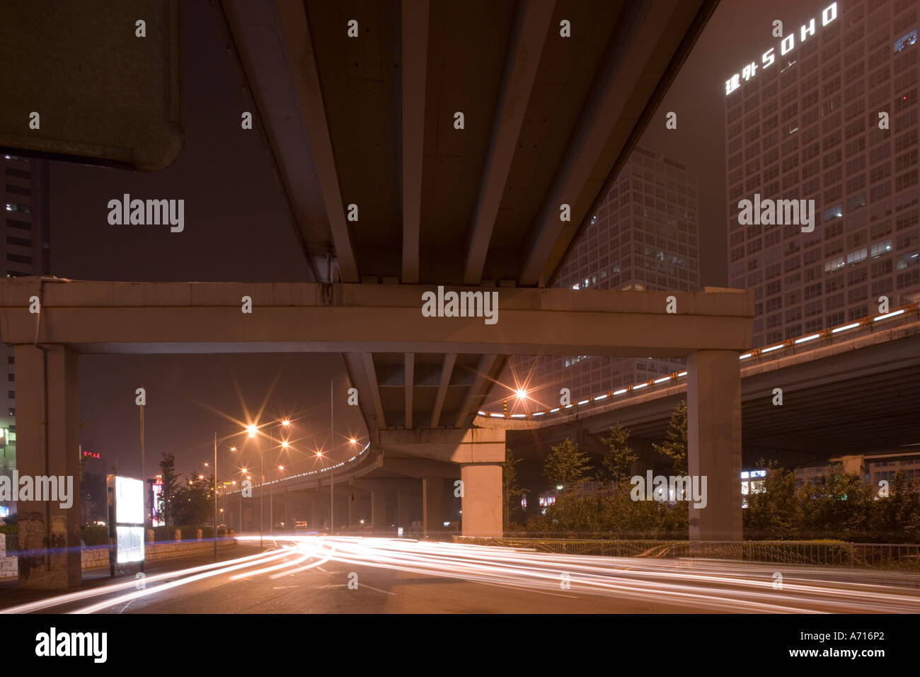 Asia China Beijing Lights of highway overpass and office towers in the ...