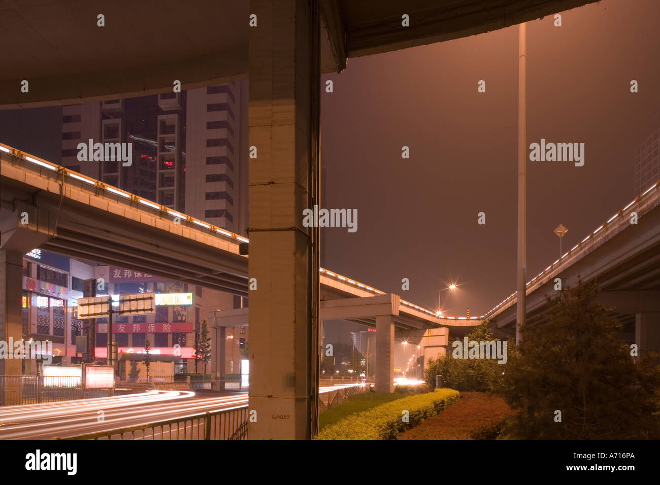 Asia China Beijing Lights of highway overpass and office towers at ...