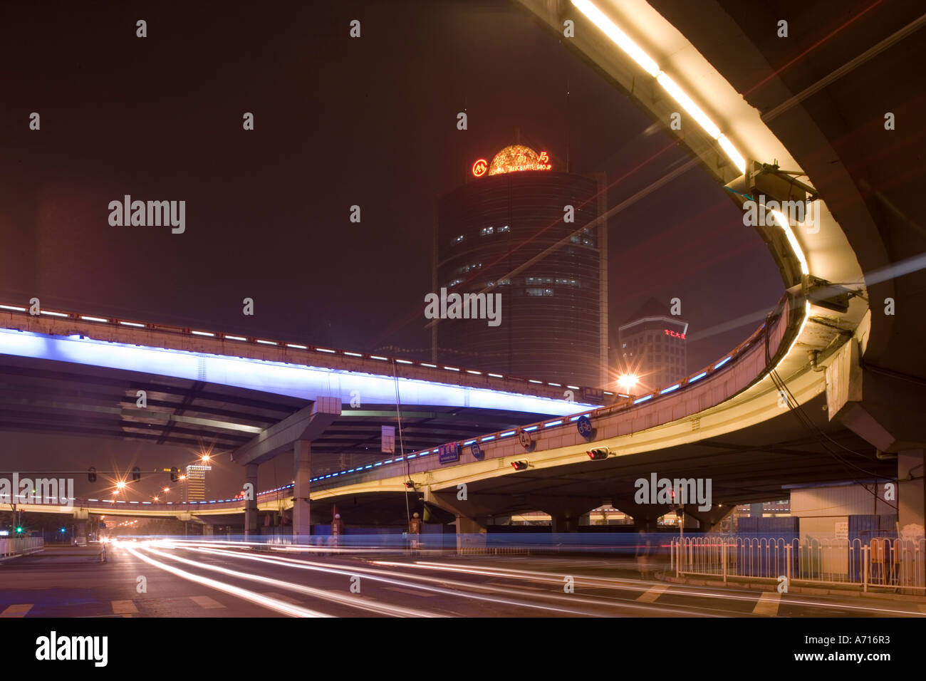 Asia China Beijing Lights of highway overpass and office towers at ...