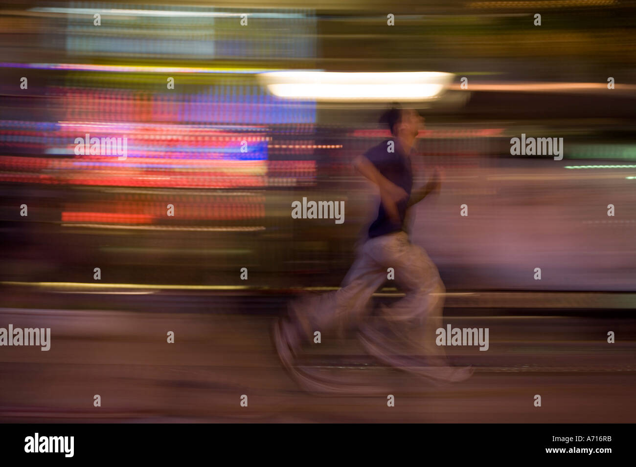 Asia China Beijing Blurred image of young Chinese man running through ...