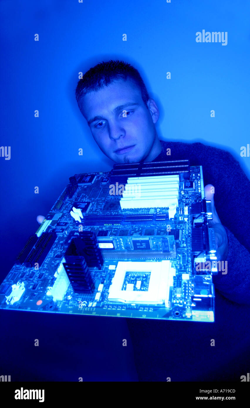 Vertical color image of an adult male holding internal computer parts ...
