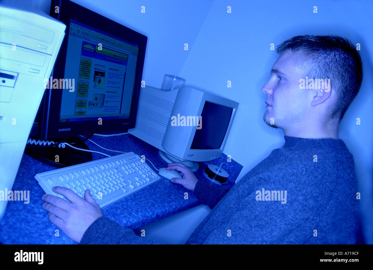 Horizontal color image of an adult male working at a computer ...
