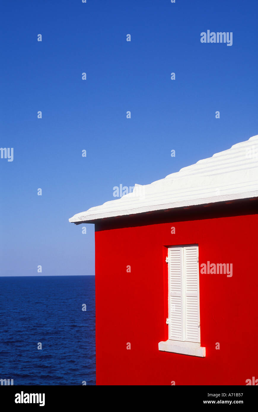 Red wall and white window in Bermuda Stock Photo - Alamy