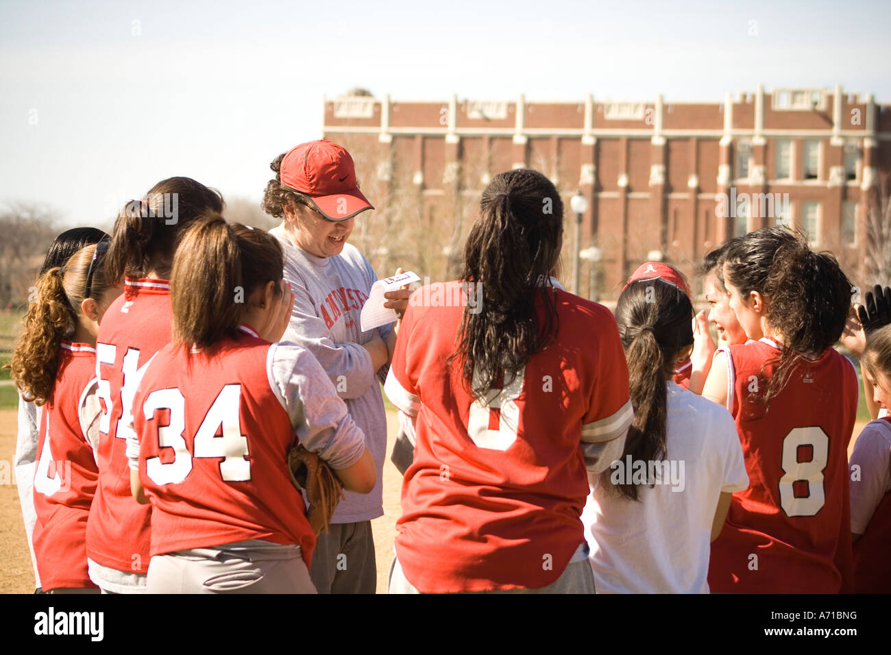 coach giving pep talk to high school girls softball team Stock Photo ...