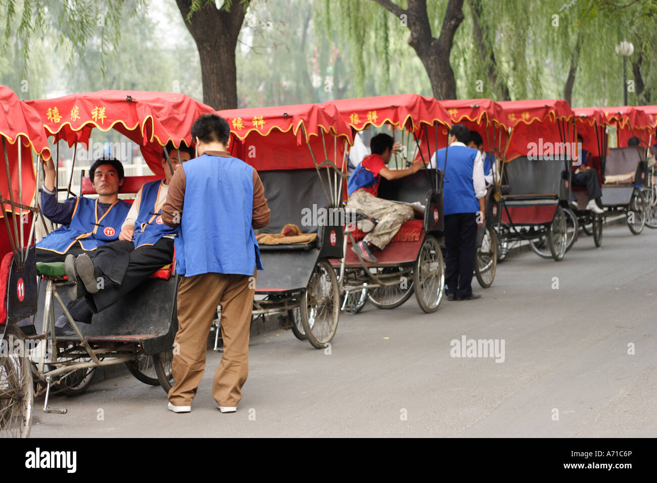 Cycle Rickshaw drivers lined up along Houhai Lake waiting for tourists ...