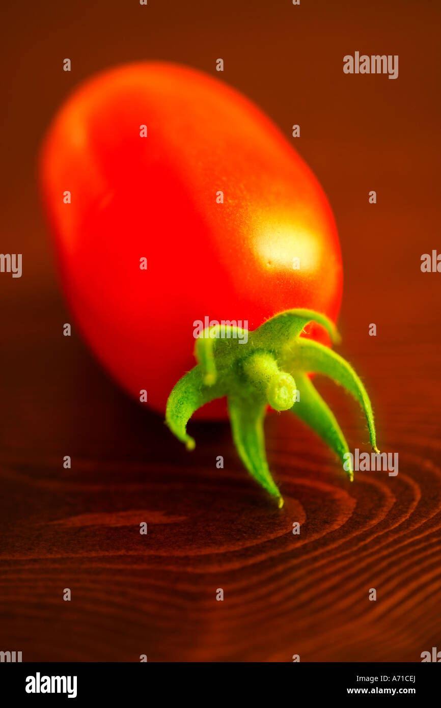 Bright red tomato on wooden table Stock Photo - Alamy