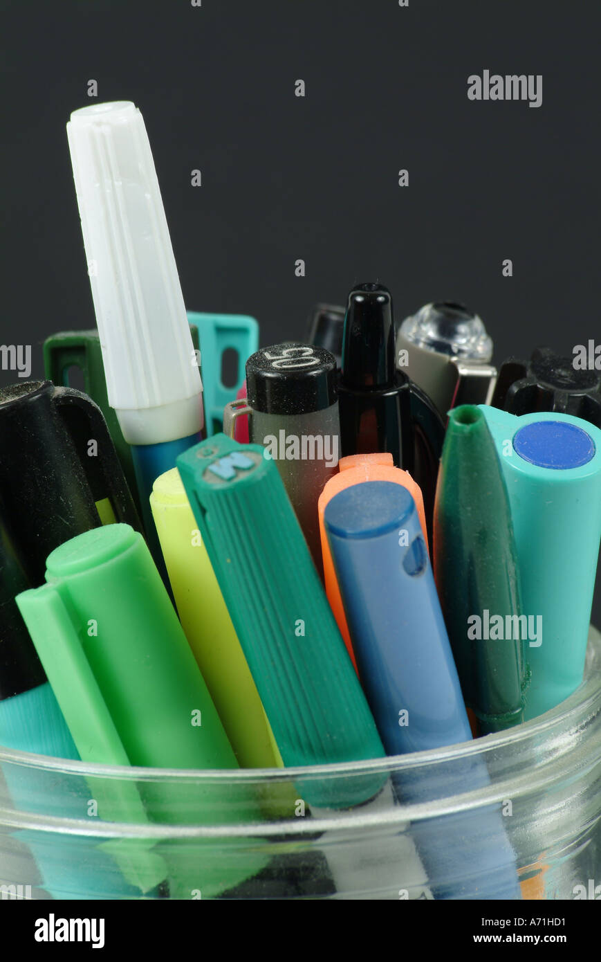 Collection of pens and markers in a clear glass jar Stock Photo - Alamy