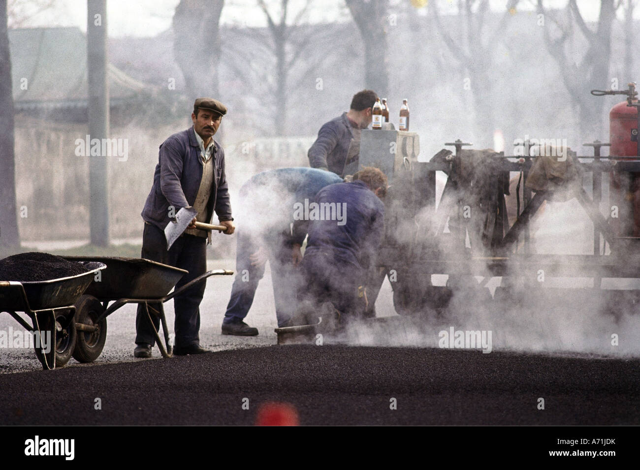 building industry, roadworks, workers tarring street, roadmaking, tar ...