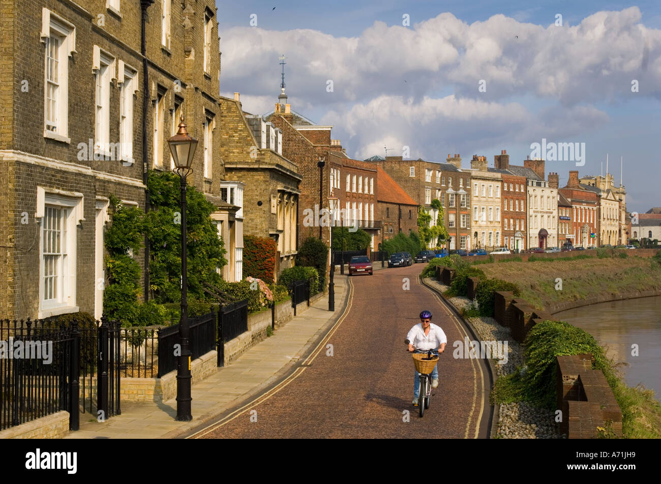 Cycling along North Brink in fenland town of Wisbech in Cambridgeshire ...