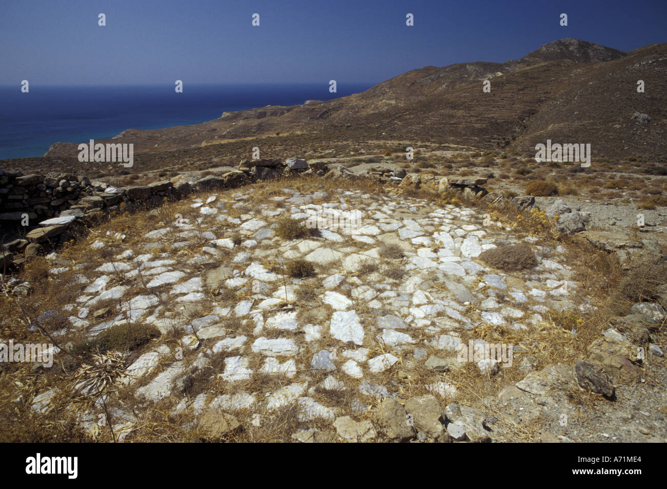 Europe, Greece, Cyclades Islands, Anafi. Circular stone-paved threshing ...