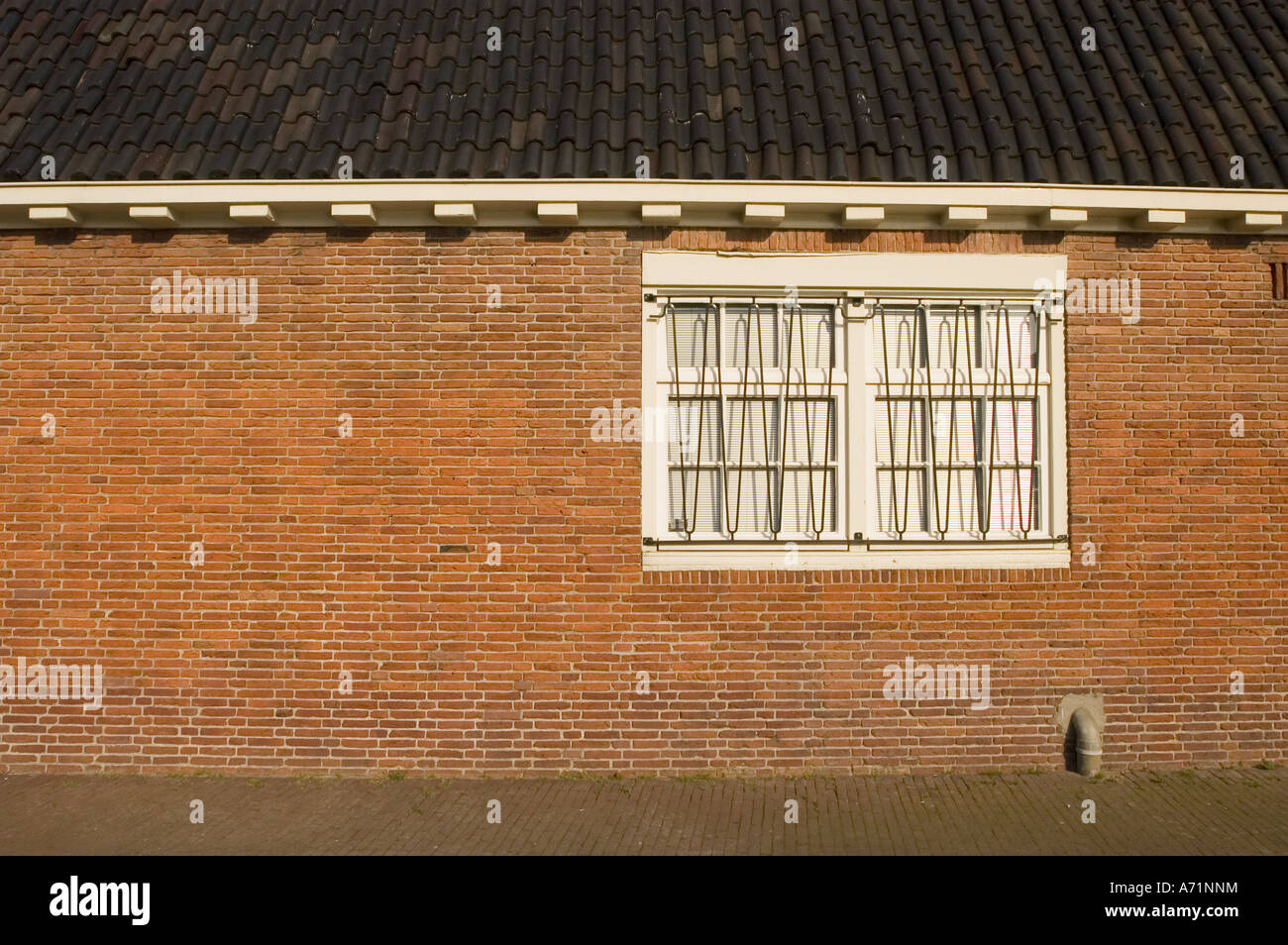 Red brick wall with single window in Amsterdam Netherlands Holland ...