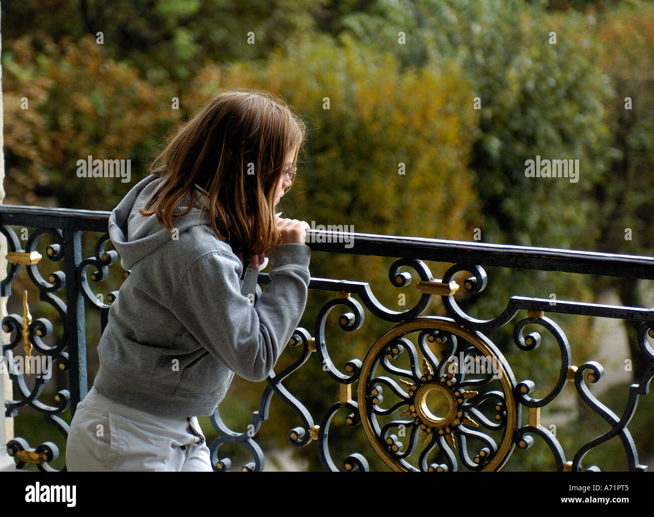 Girl looking out from balcony Stock Photo - Alamy