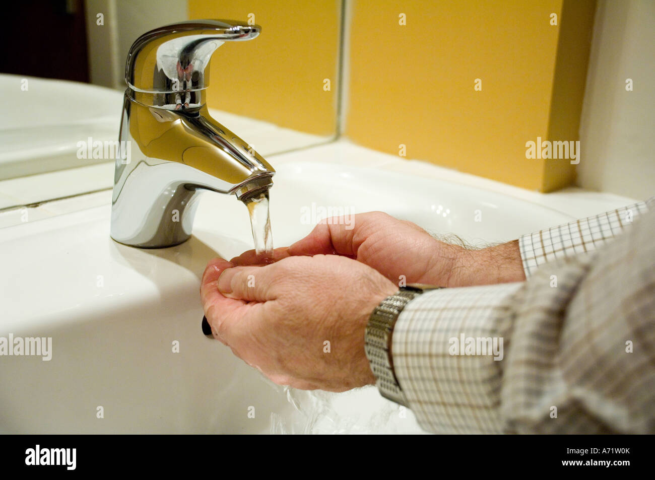 A man washing his hands, in a bathroom Stock Photo - Alamy