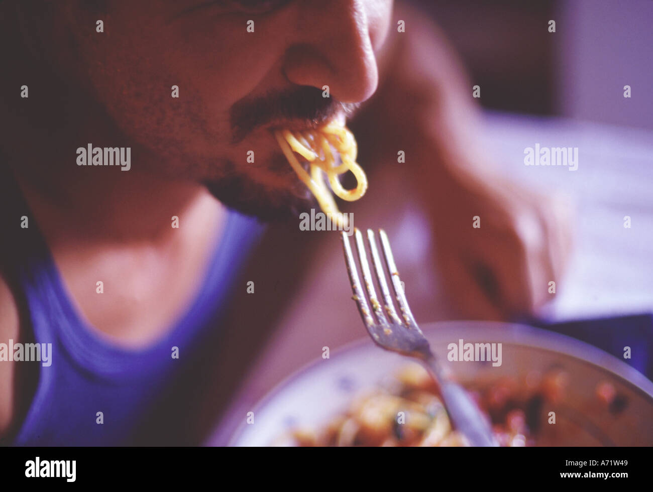 Man eating spaghetti with tomato sauce hi-res stock photography and ...