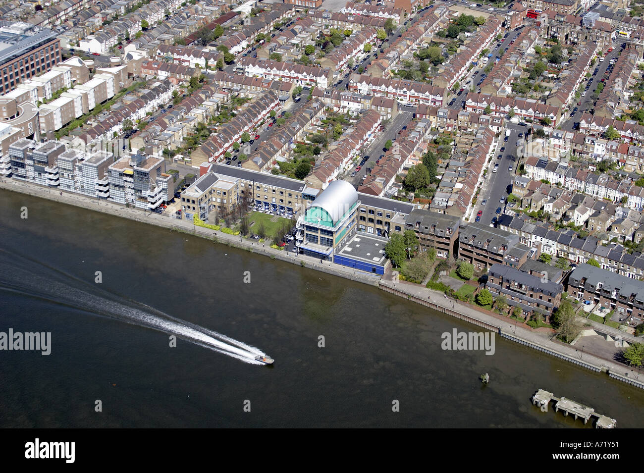 Aerial high level oblique view north east of suburbs and houses of ...